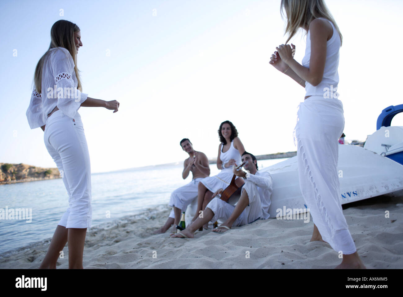 Group of young people at beach party, Mallorca Stock Photo - Alamy