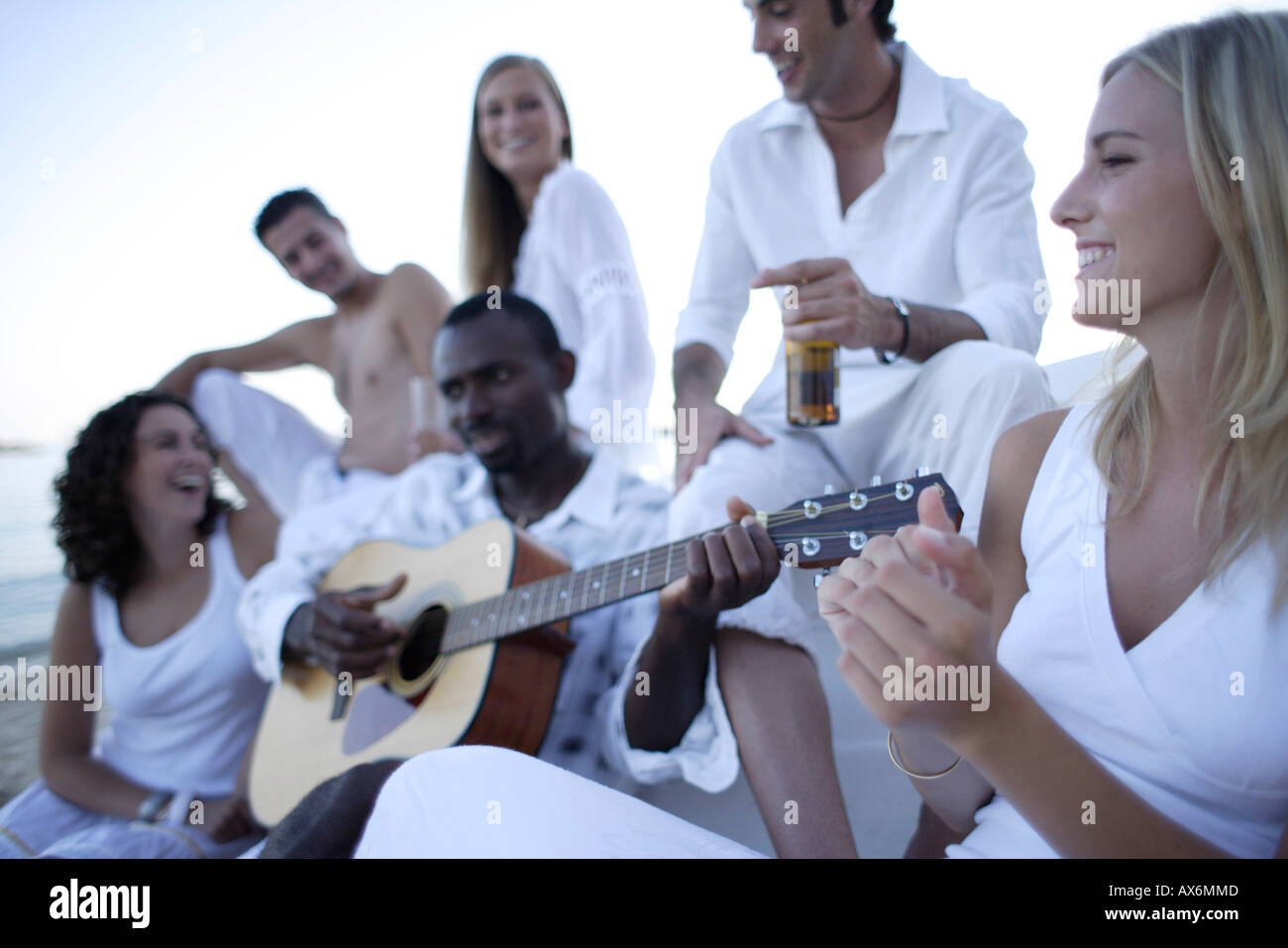 Group of young people at beach party, Mallorca Stock Photo - Alamy