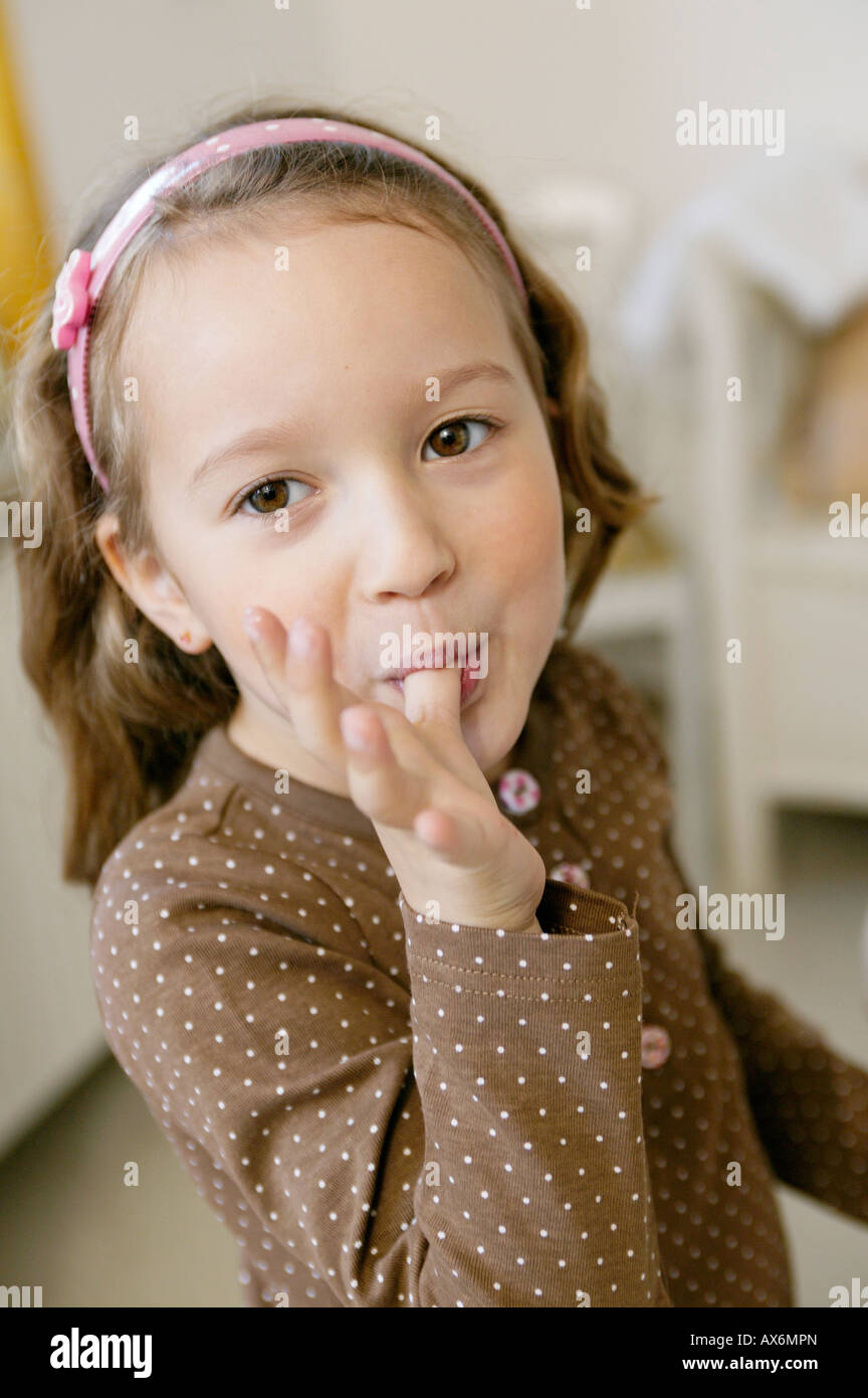 Child licking thumb hi-res stock photography and images - Alamy