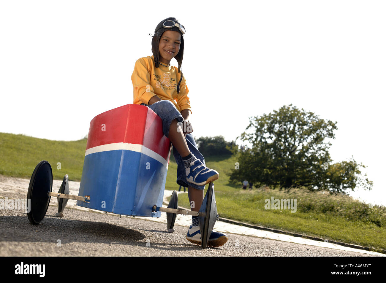 Portrait of boy sitting on soapbox and smiling Stock Photo - Alamy