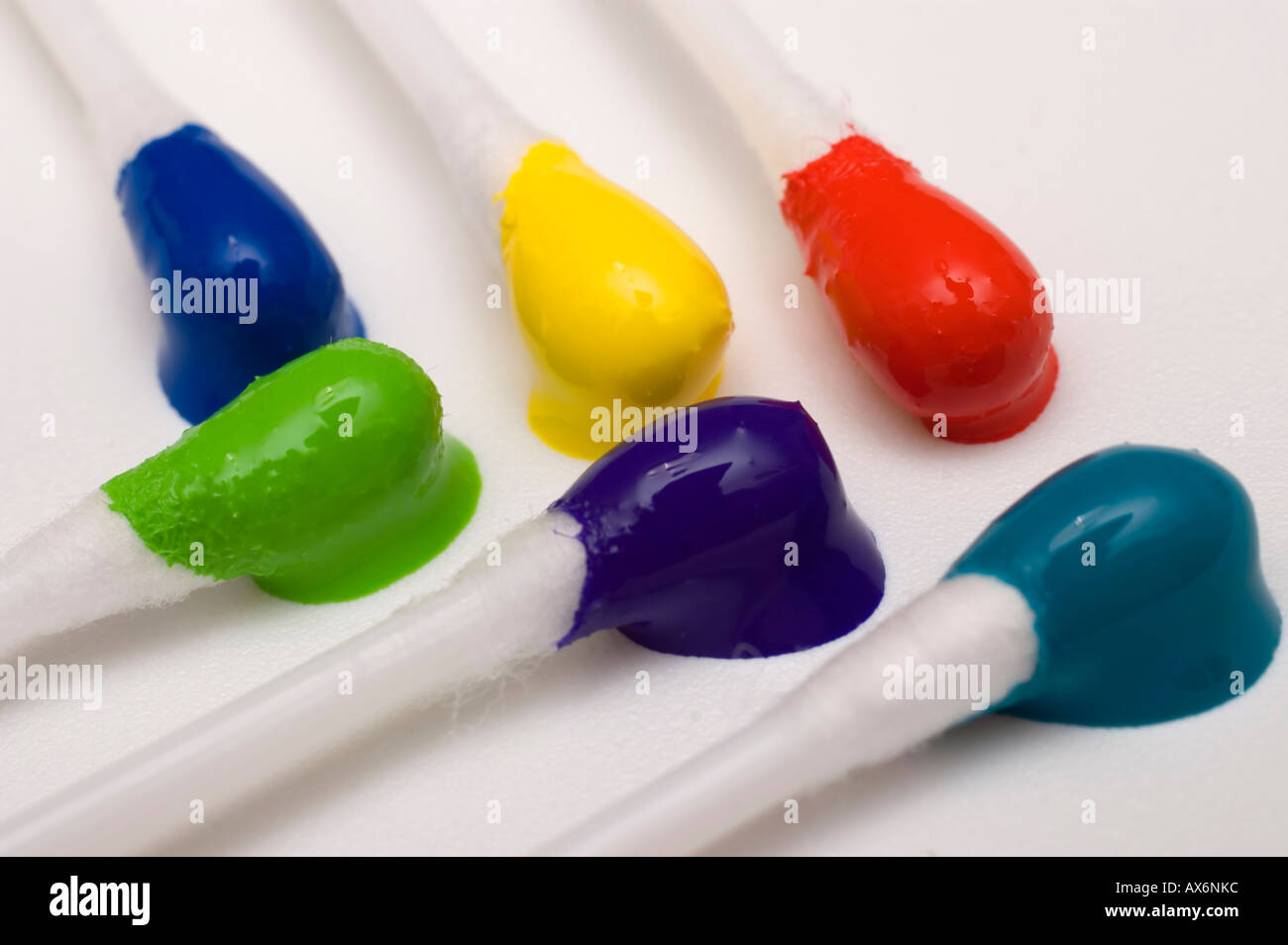 colourful Q tips dipped in red blue green and yellow paint Stock Photo ...