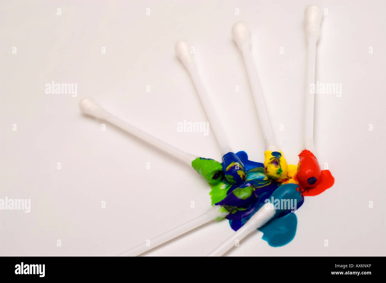 colourful Q tips dipped in red blue green and yellow paint Stock Photo ...