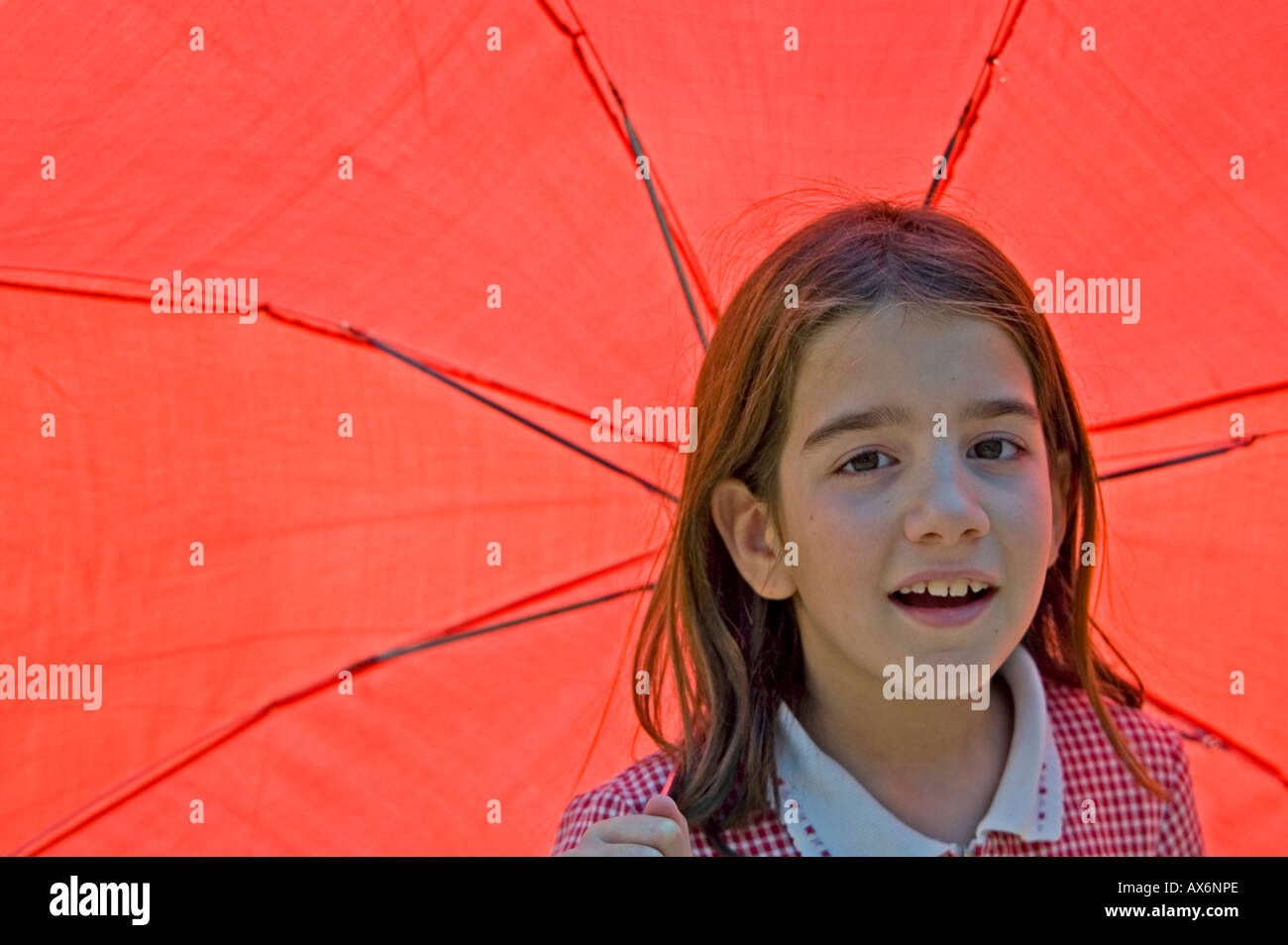 Young girl 8 years old with a red umbrella Stock Photo - Alamy