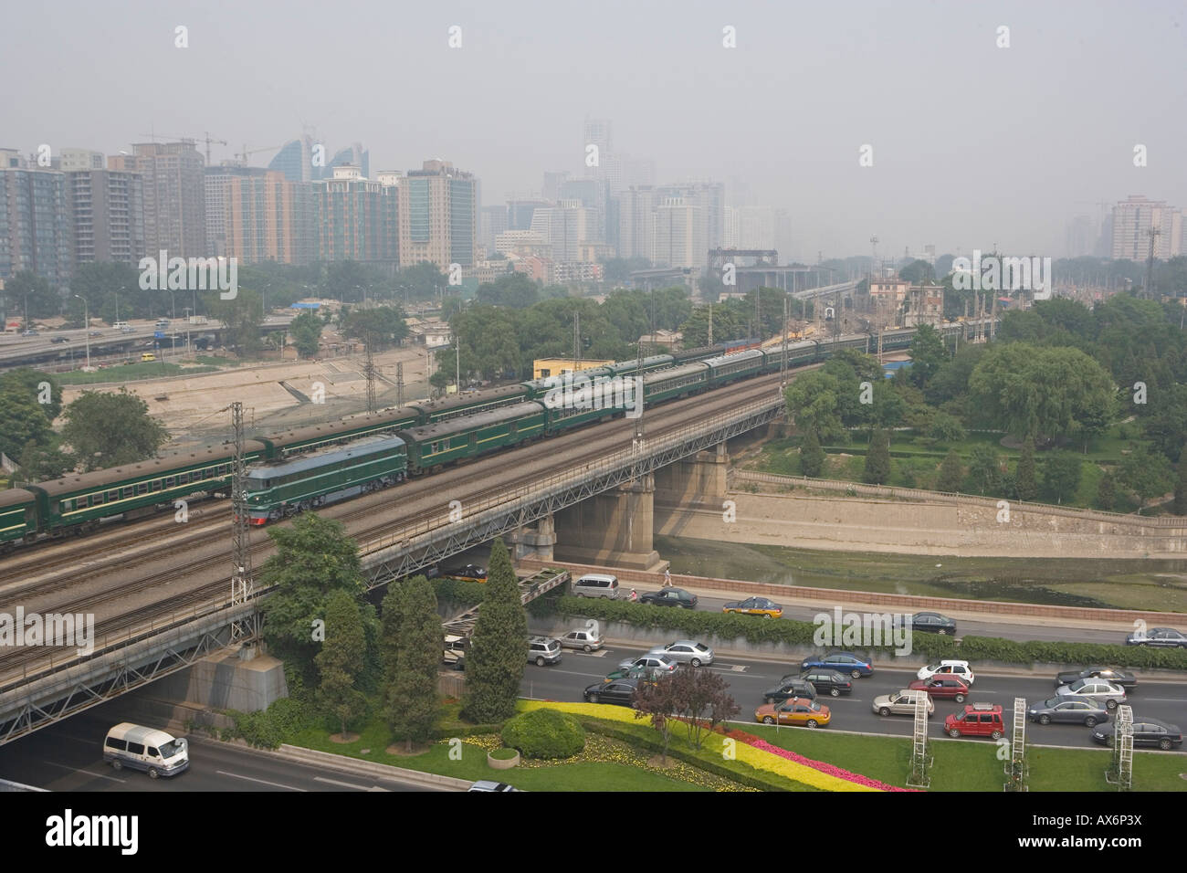 Train crossing bridge over highway, China Stock Photo - Alamy
