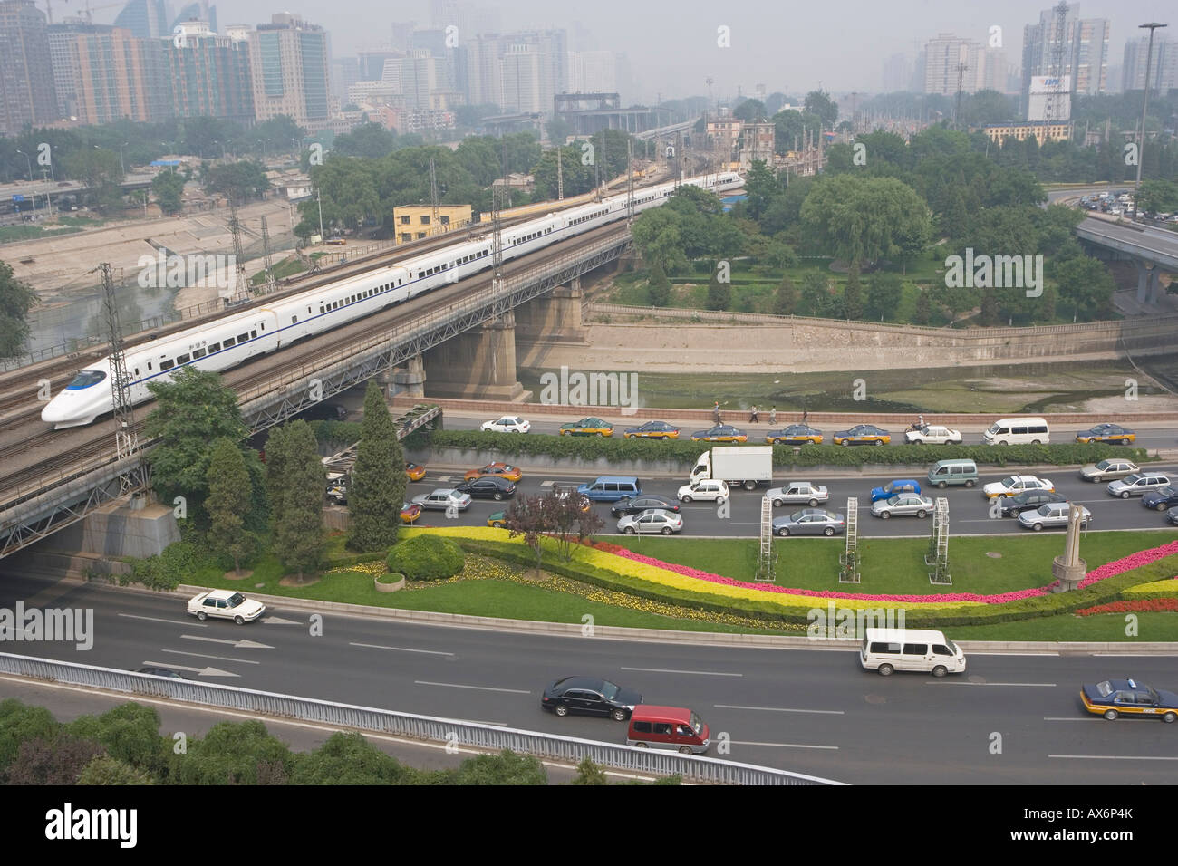 Train crossing bridge over highway, China Stock Photo - Alamy