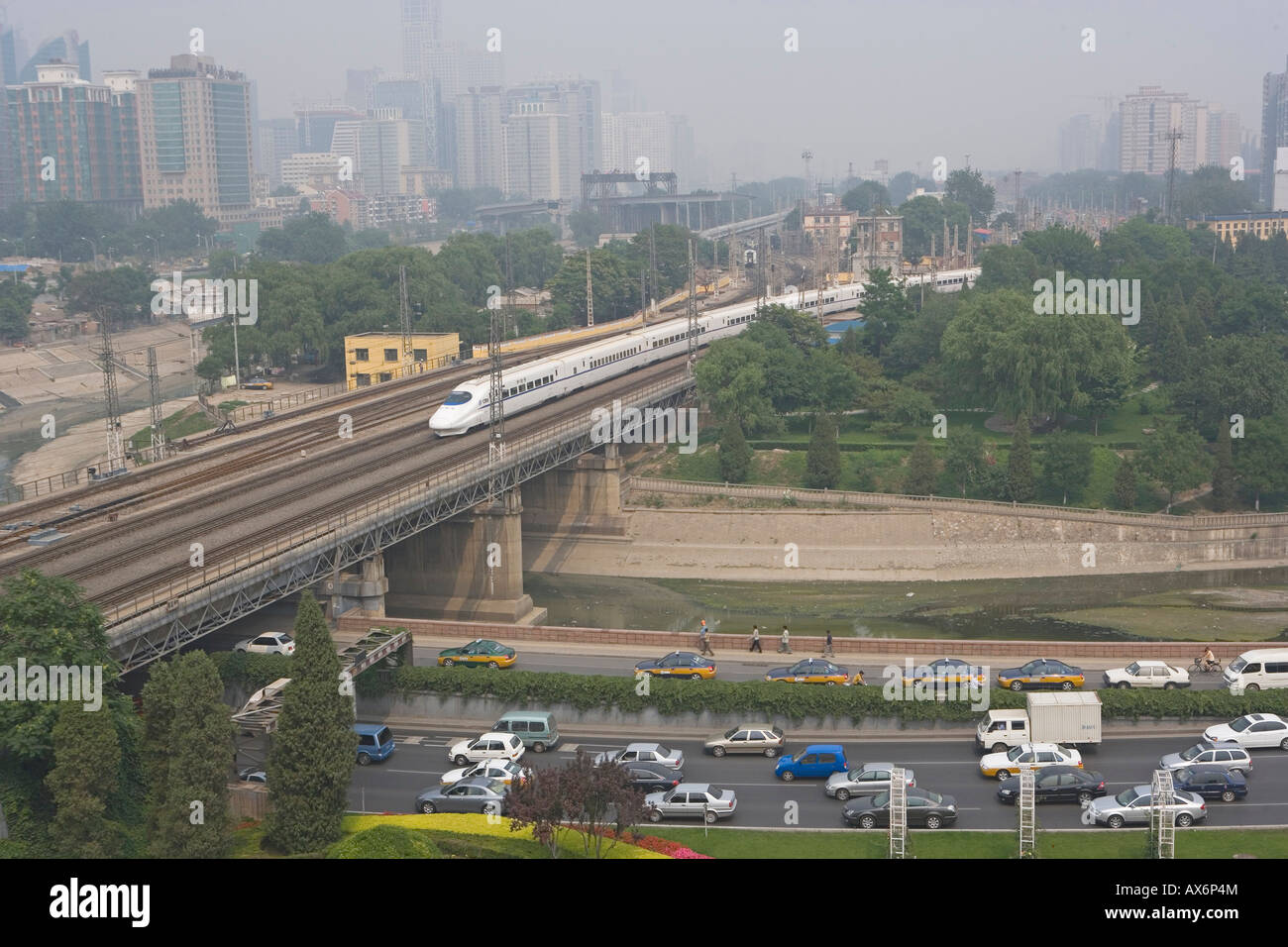 Train crossing bridge over highway, China Stock Photo - Alamy