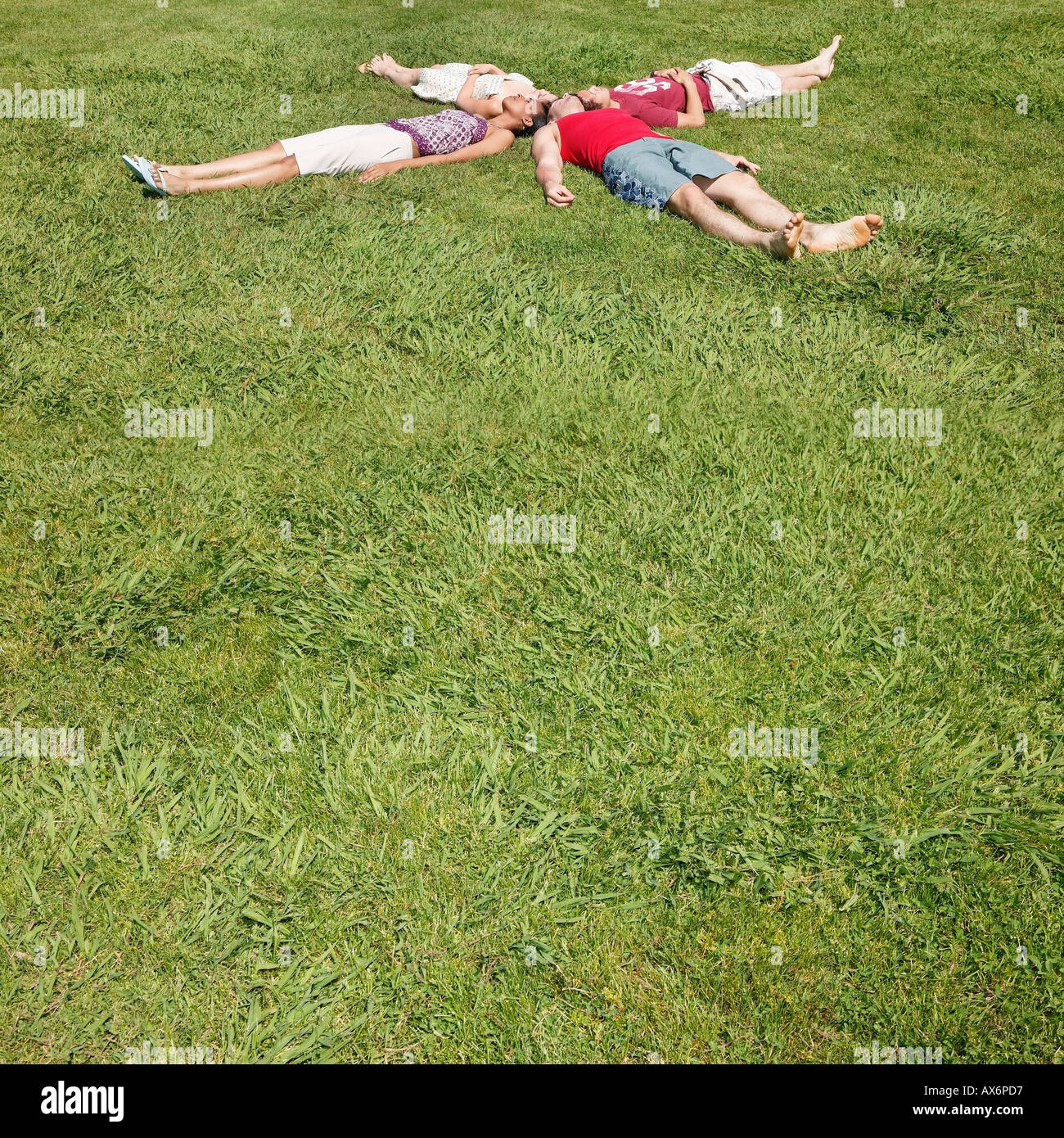 Friends lying on the grass Stock Photo - Alamy