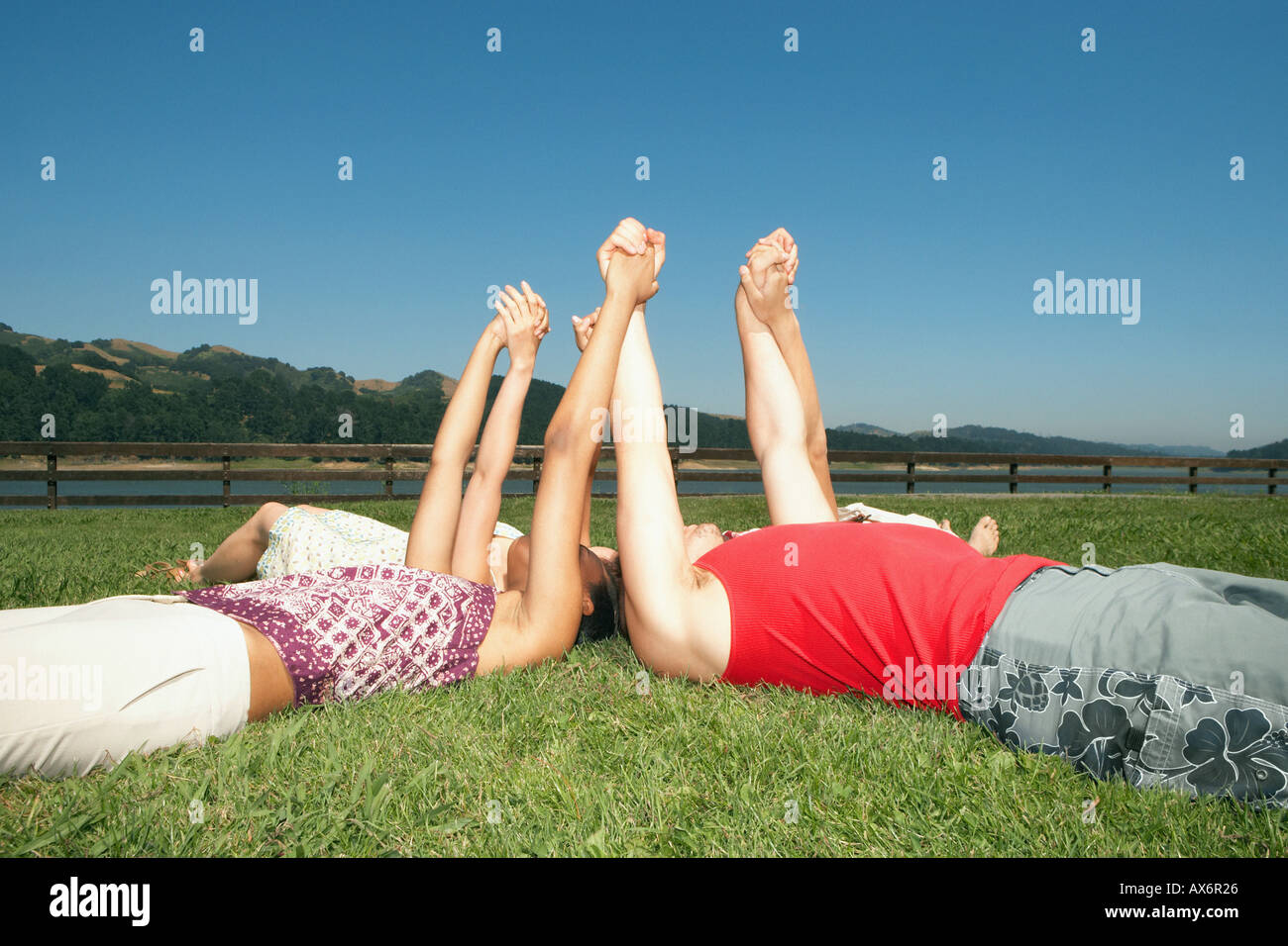 Four friends holding hands arms hi-res stock photography and images - Alamy