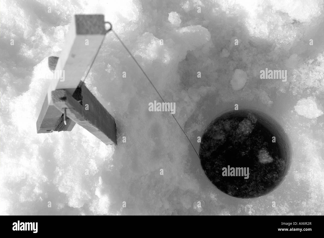 A trap setup for ice fishing on a river Stock Photo - Alamy