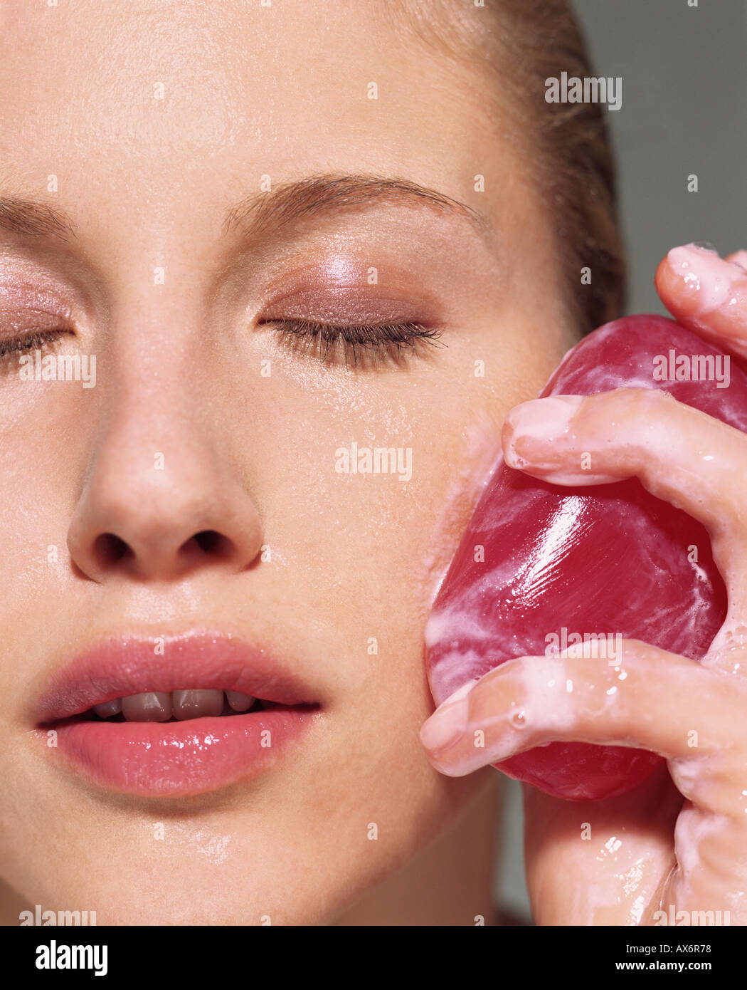 Woman cleansing her face with soap Stock Photo - Alamy