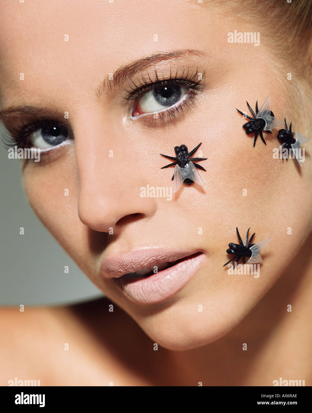 Woman with plastic flies on her face Stock Photo - Alamy
