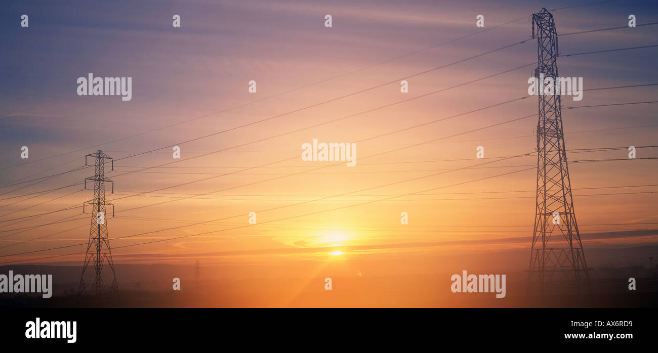 Electricity pylons at sunrise Stock Photo - Alamy