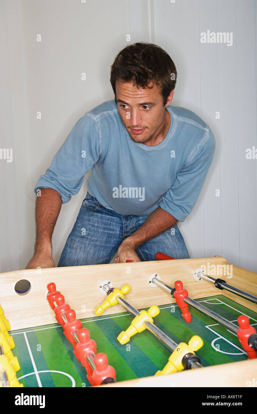Man playing table football Stock Photo - Alamy
