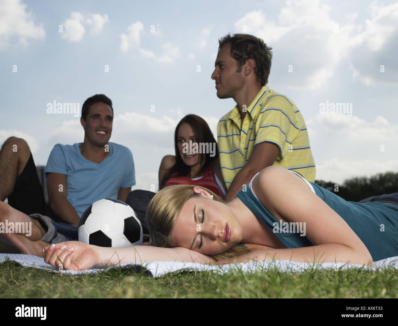 Young people resting in a field Stock Photo - Alamy