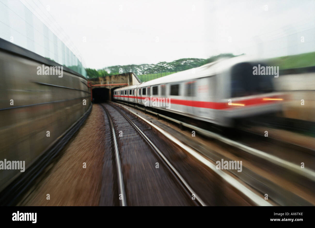 The MRT or subway of Singapore. A train emerges from the underground ...