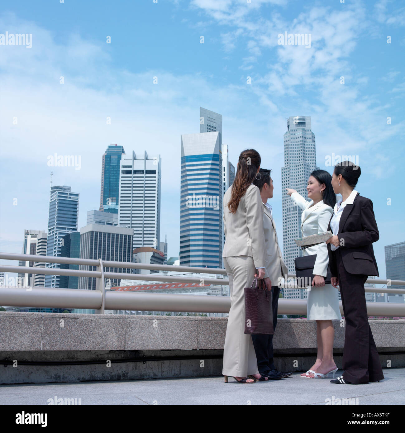Business people smiling pointing towards hi-res stock photography and ...