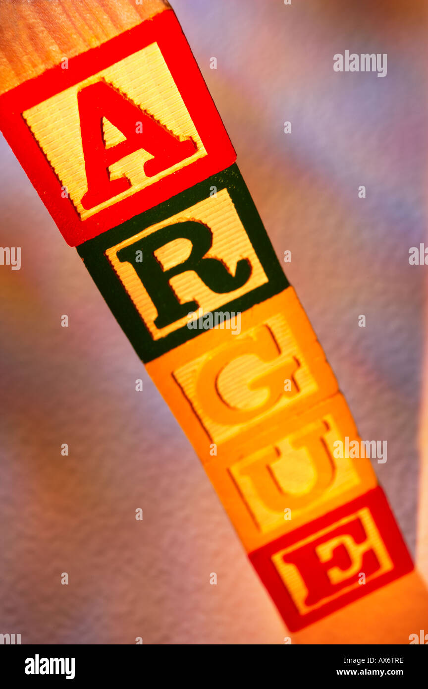 STACK OF WOODEN TOY BUILDING BLOCKS SPELLING THE WORD ARGUE Stock Photo ...