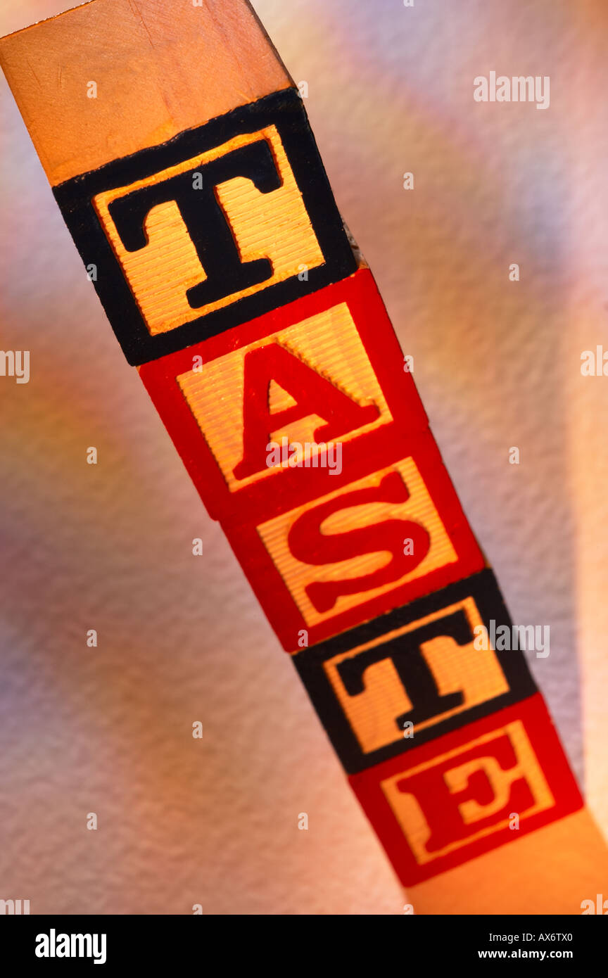 STACK OF WOODEN TOY BUILDING BLOCKS SPELLING THE WORD TASTE Stock Photo ...