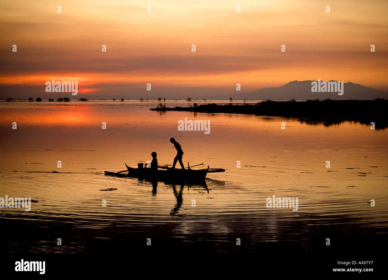 Two fishermen in boat sunset Manila Bay Philippines Stock Photo - Alamy