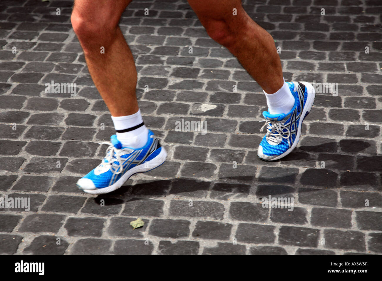 man running in blue training shoes Stock Photo - Alamy
