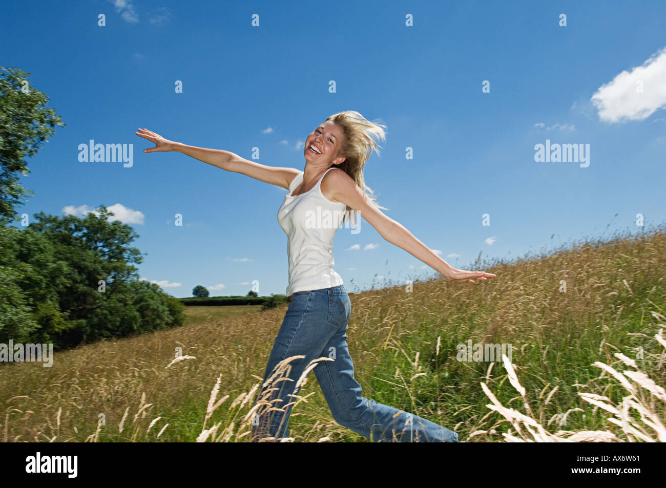 Woman walking in the countryside Stock Photo - Alamy