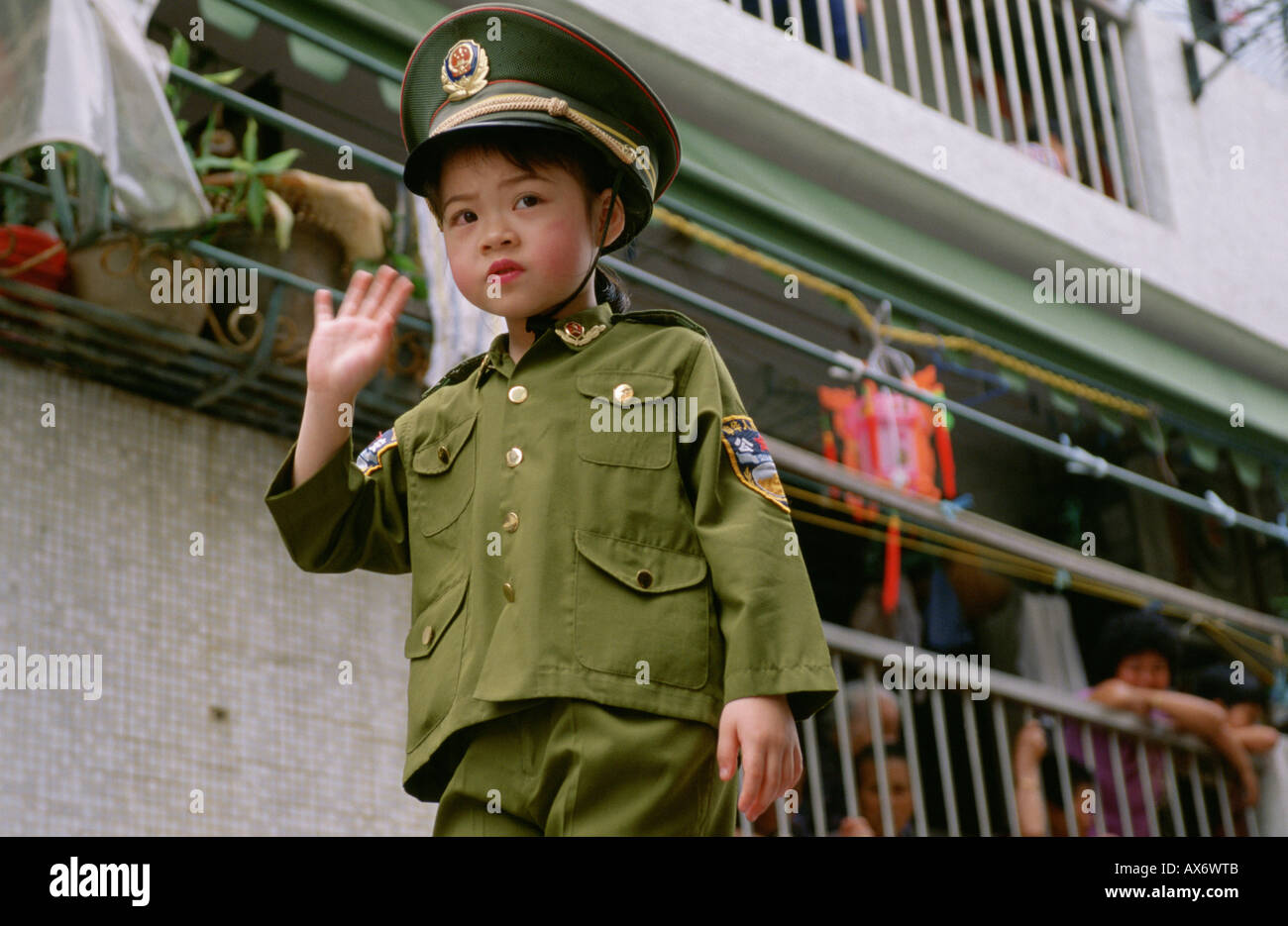 A young Chinese girl dressed as a People s Liberation Army Soldier is ...