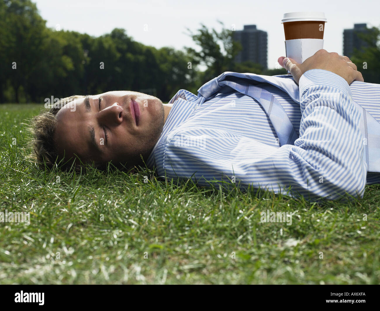 Man sleeping in the park Stock Photo - Alamy