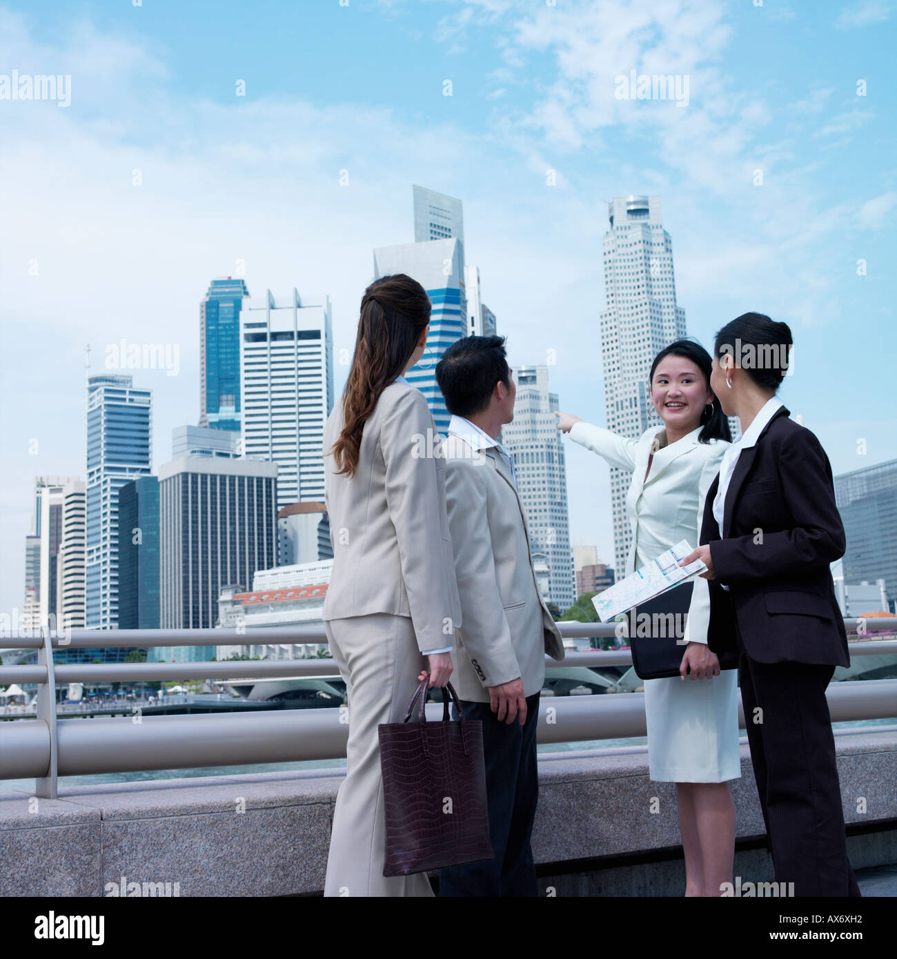 Business people smiling pointing towards hi-res stock photography and ...