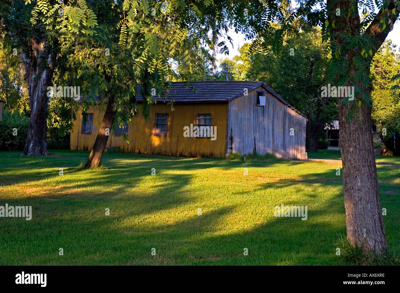 an old dilapidated shack in a well maintained garden Stock Photo - Alamy