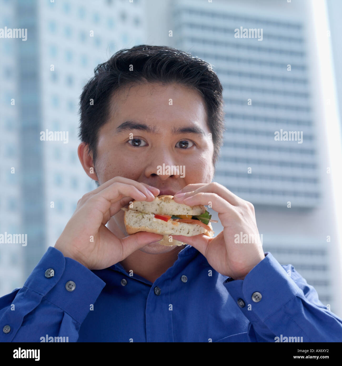 Portrait of a businessman eating a burger Stock Photo - Alamy