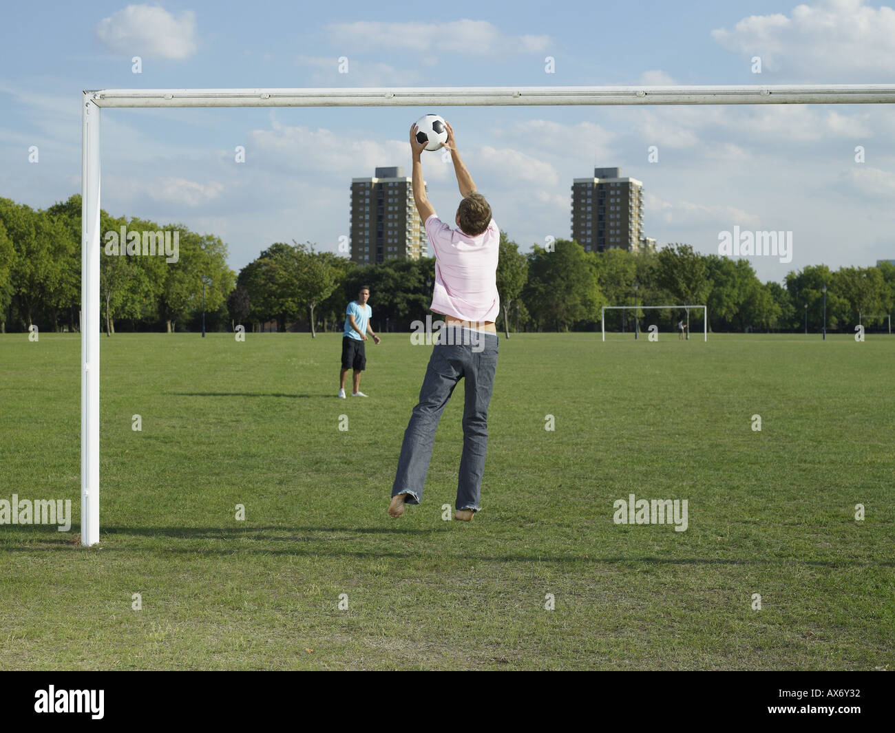 Football in arms hi-res stock photography and images - Alamy