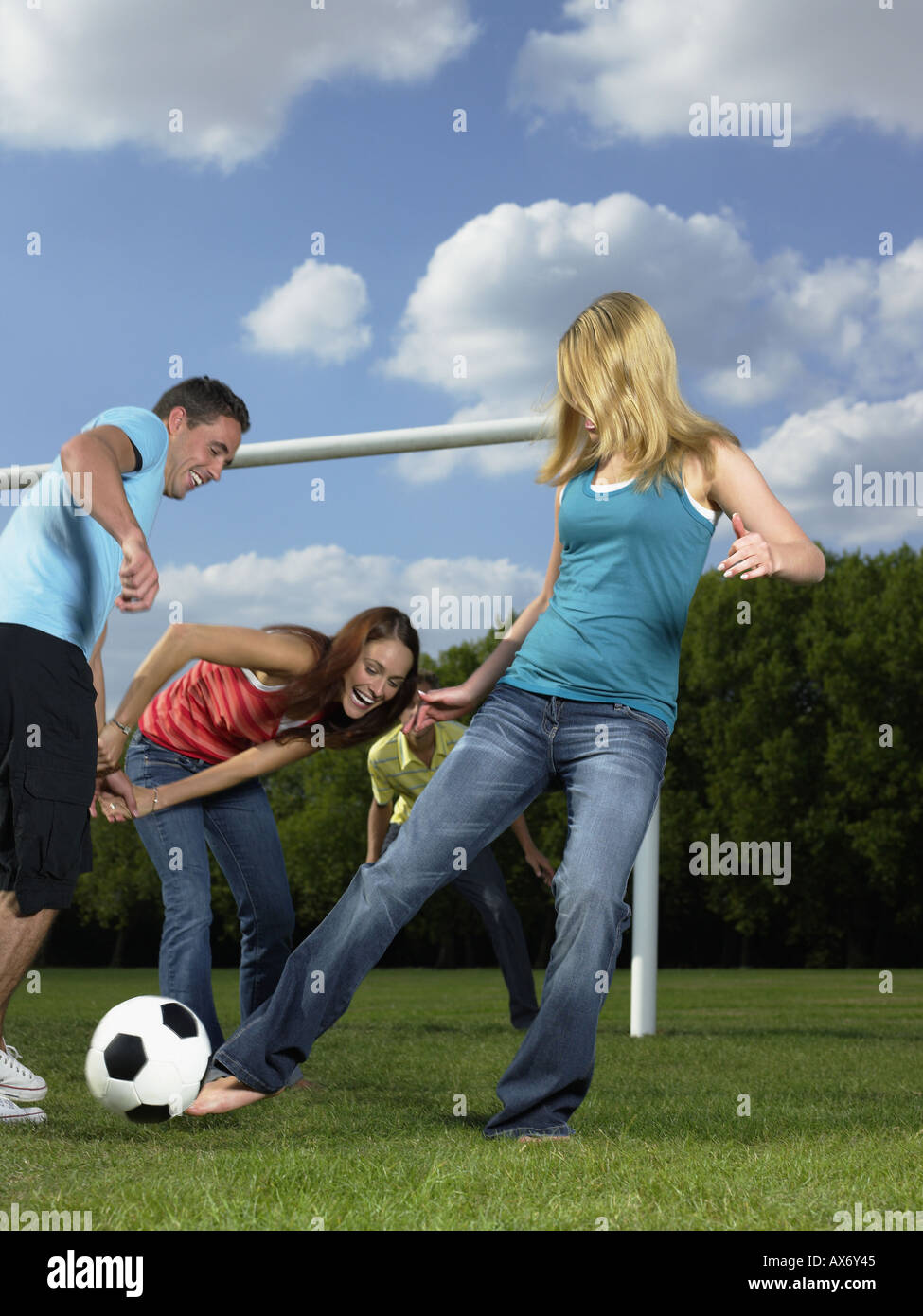 Adult friends playing football park hi-res stock photography and images ...