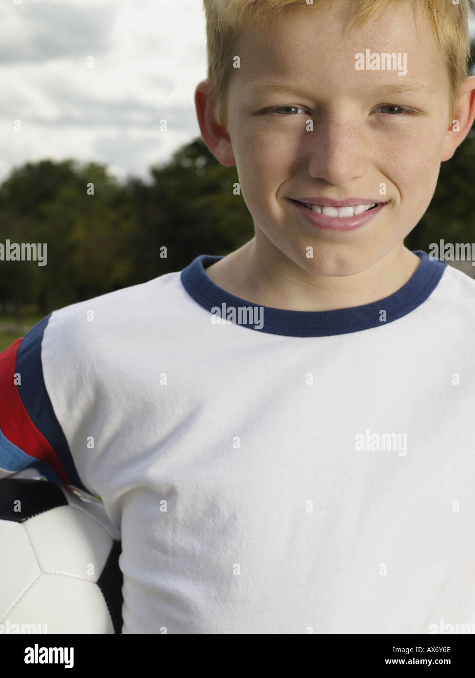 Boy holding a football Stock Photo - Alamy