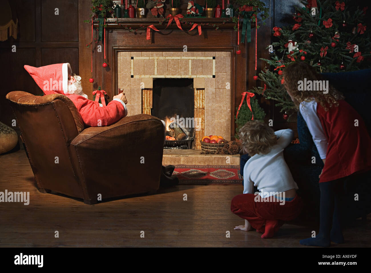 Children watching santa claus in living room Stock Photo - Alamy