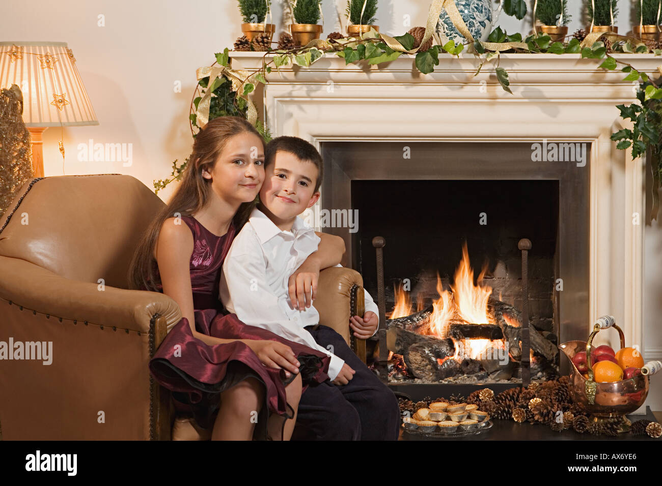 Children by fireplace at christmas Stock Photo - Alamy