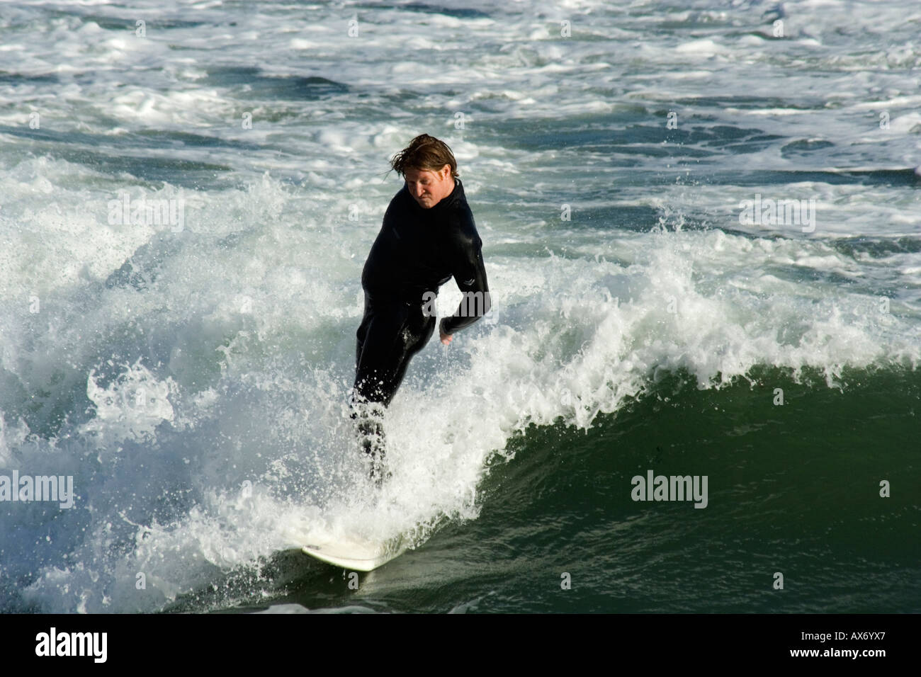 Surf Boarder riding a wave at Bournemouth, Dorset, UK Stock Photo - Alamy