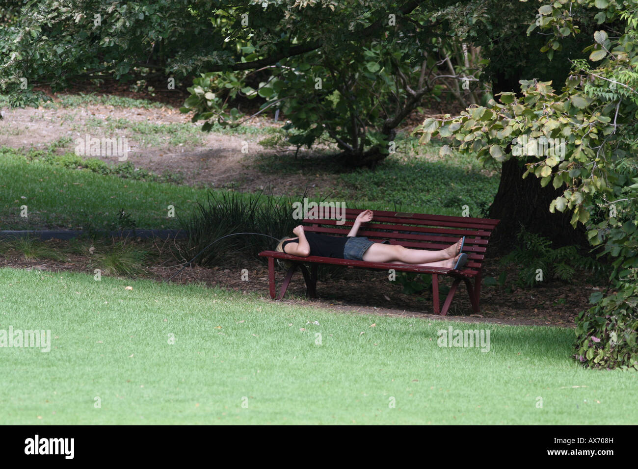 girl lying on the bench in the park Stock Photo - Alamy