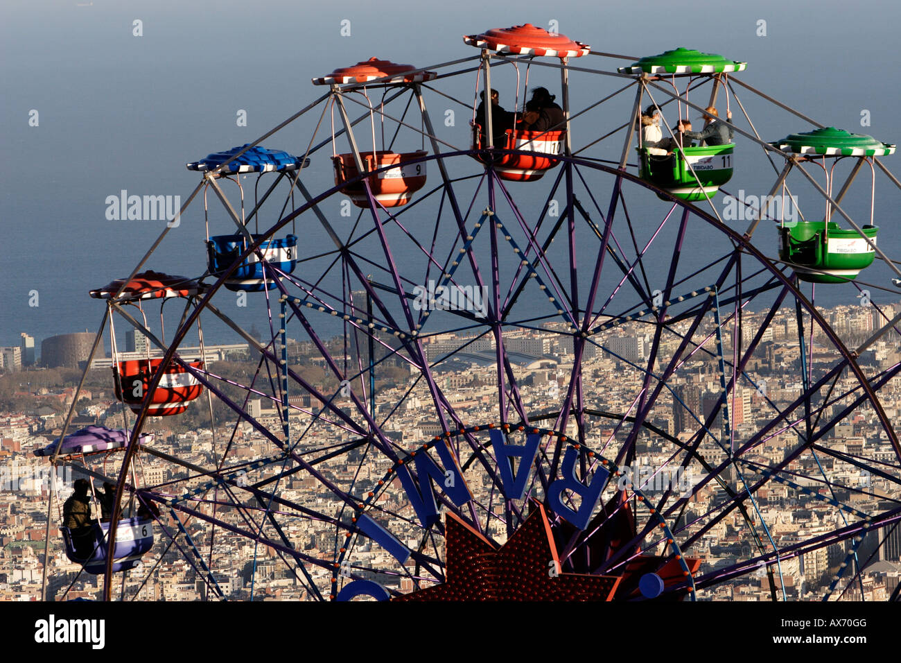 Big wheel with a view of Barcelona behind it Stock Photo - Alamy