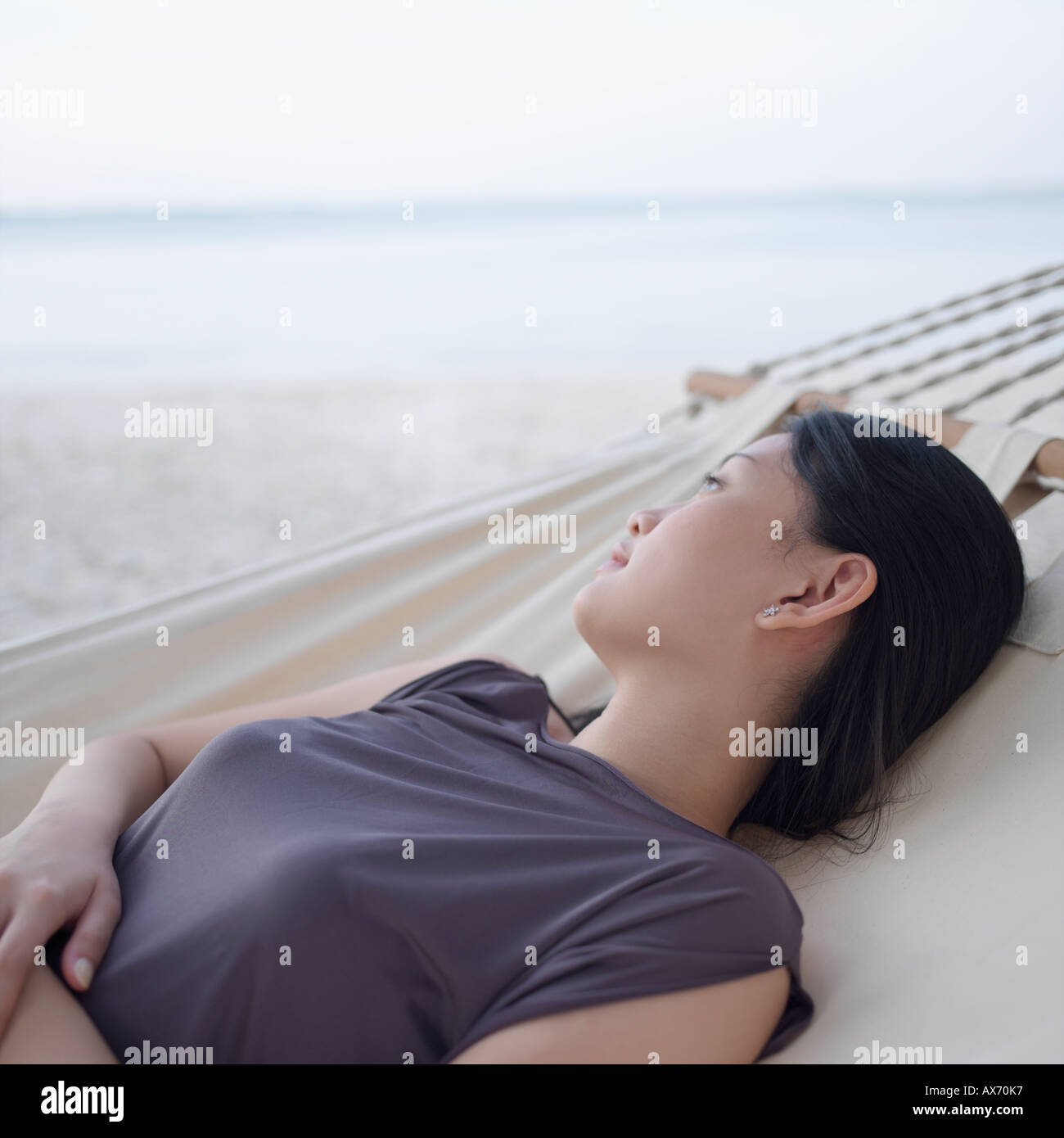 Side profile of a young woman relaxing in a hammock Stock Photo - Alamy