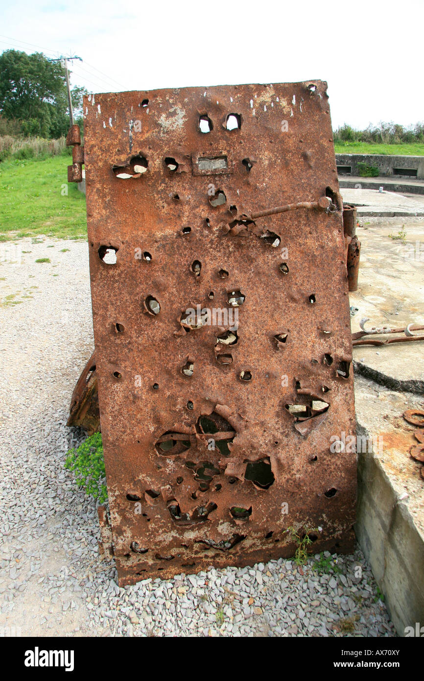 Fragmentation damage to a metal door at the Saint-Marcouf Battery ...