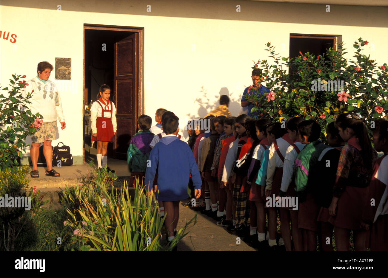 Elementary school children line up for class in front of schoolhouse ...