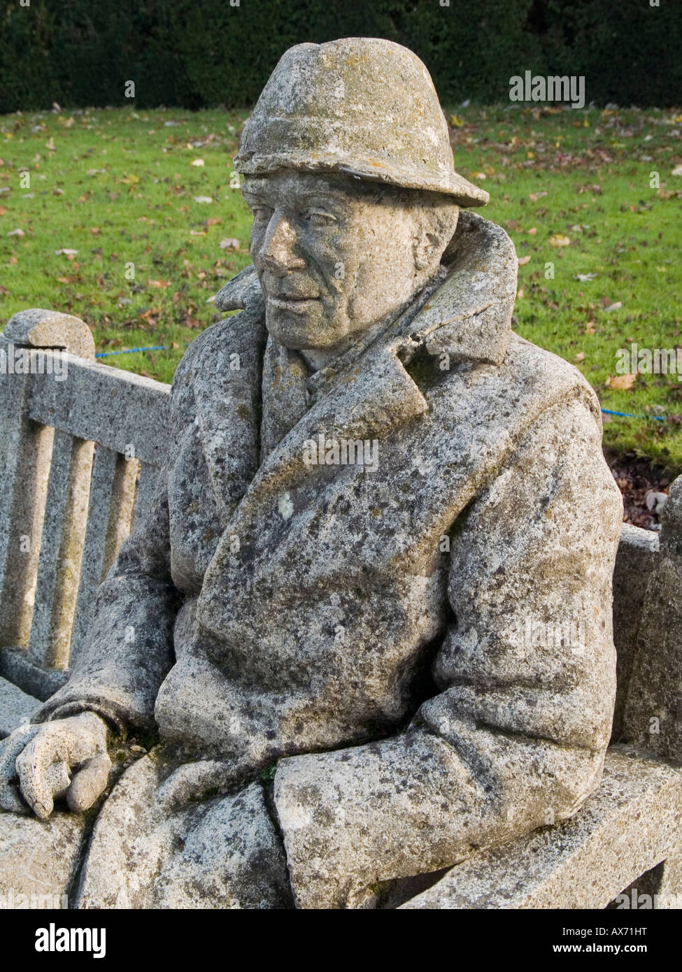 A stone man sitting on a stone bench in the gardens at Rufford Abbey ...