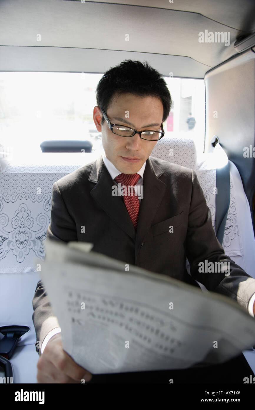 Businessman reading newspaper in car hi-res stock photography and ...