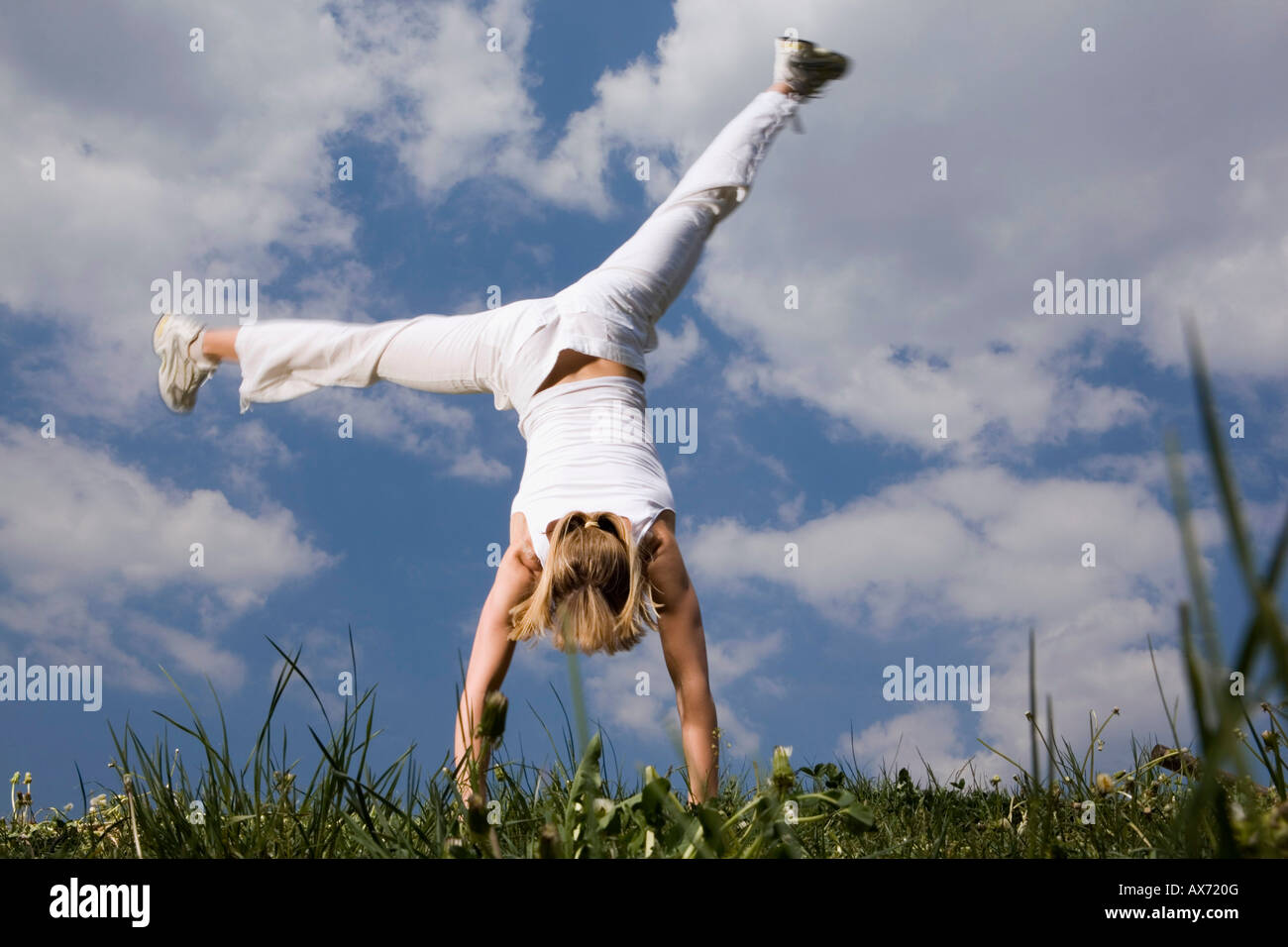 Young woman doing headstand Stock Photo - Alamy