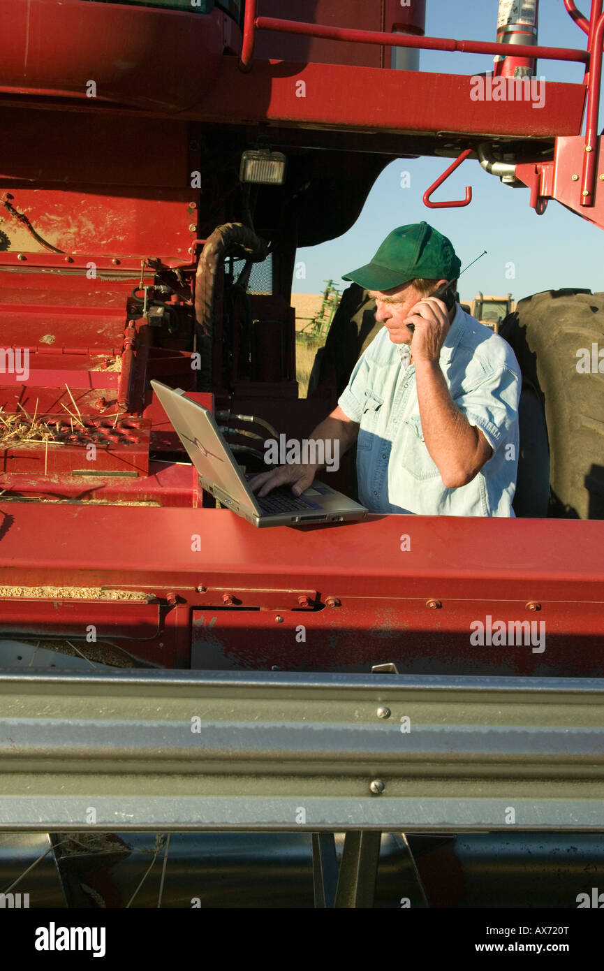 Farmer working on laptop computer, using cell phone Stock Photo - Alamy