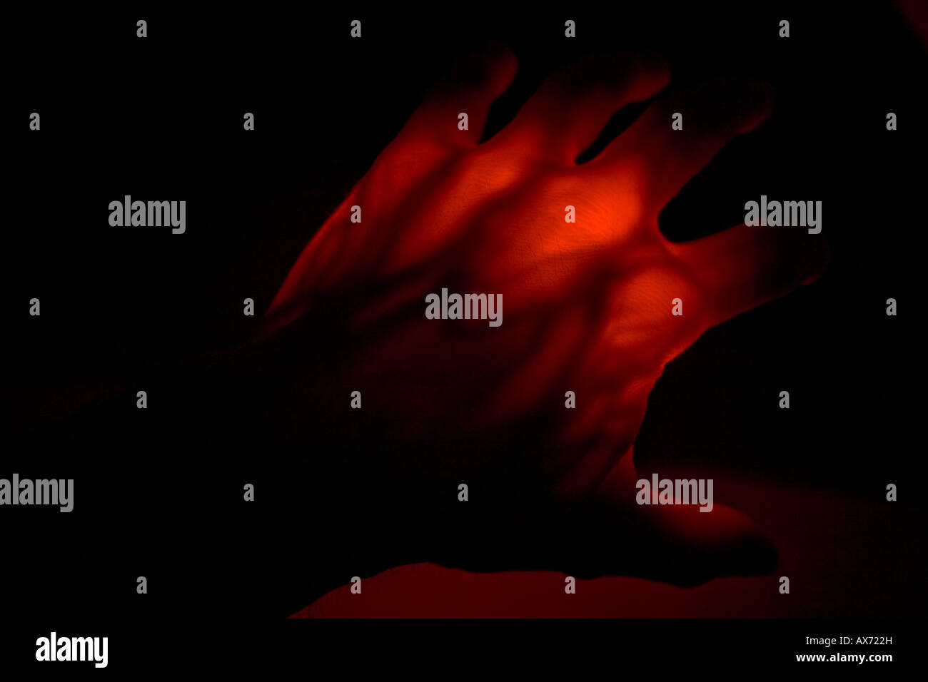 Hand with red light effect Horizontal shot Stock Photo - Alamy