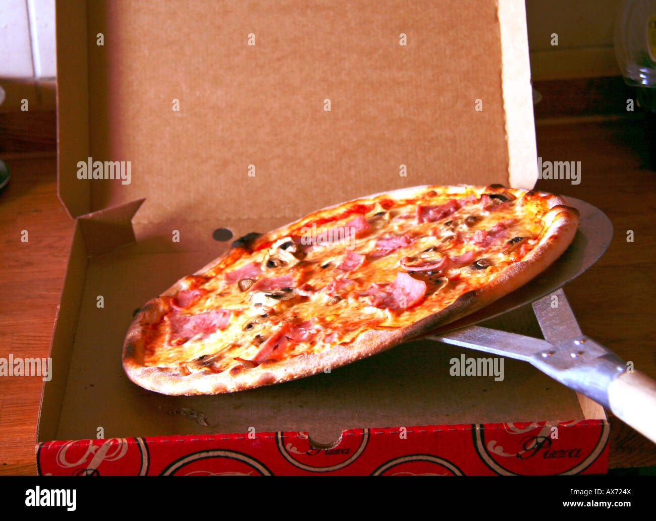 Putting an italian pizza in to the box ready for delivery Stock Photo ...