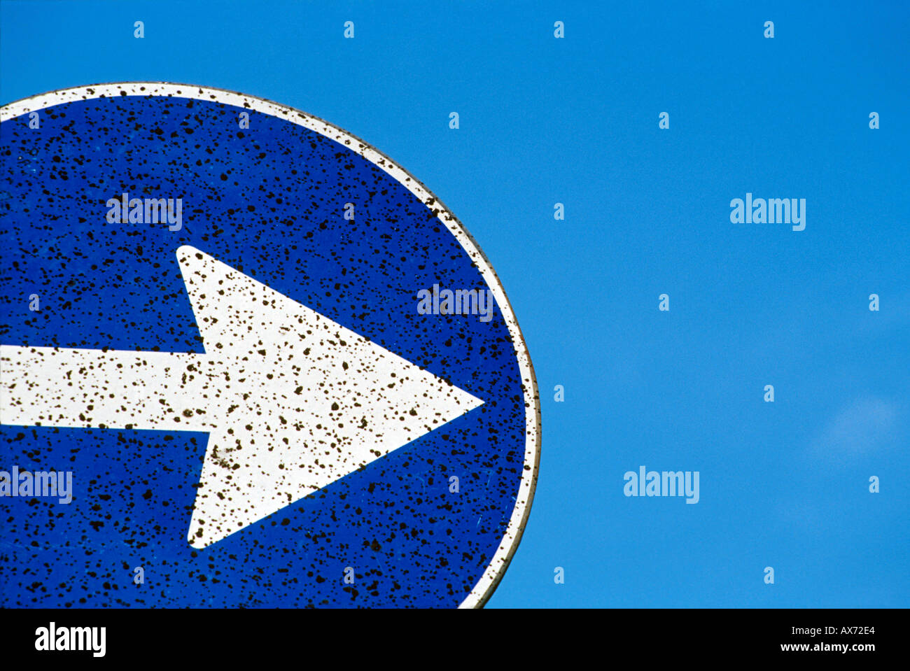 road arrow sign covered in dirt spots Stock Photo - Alamy