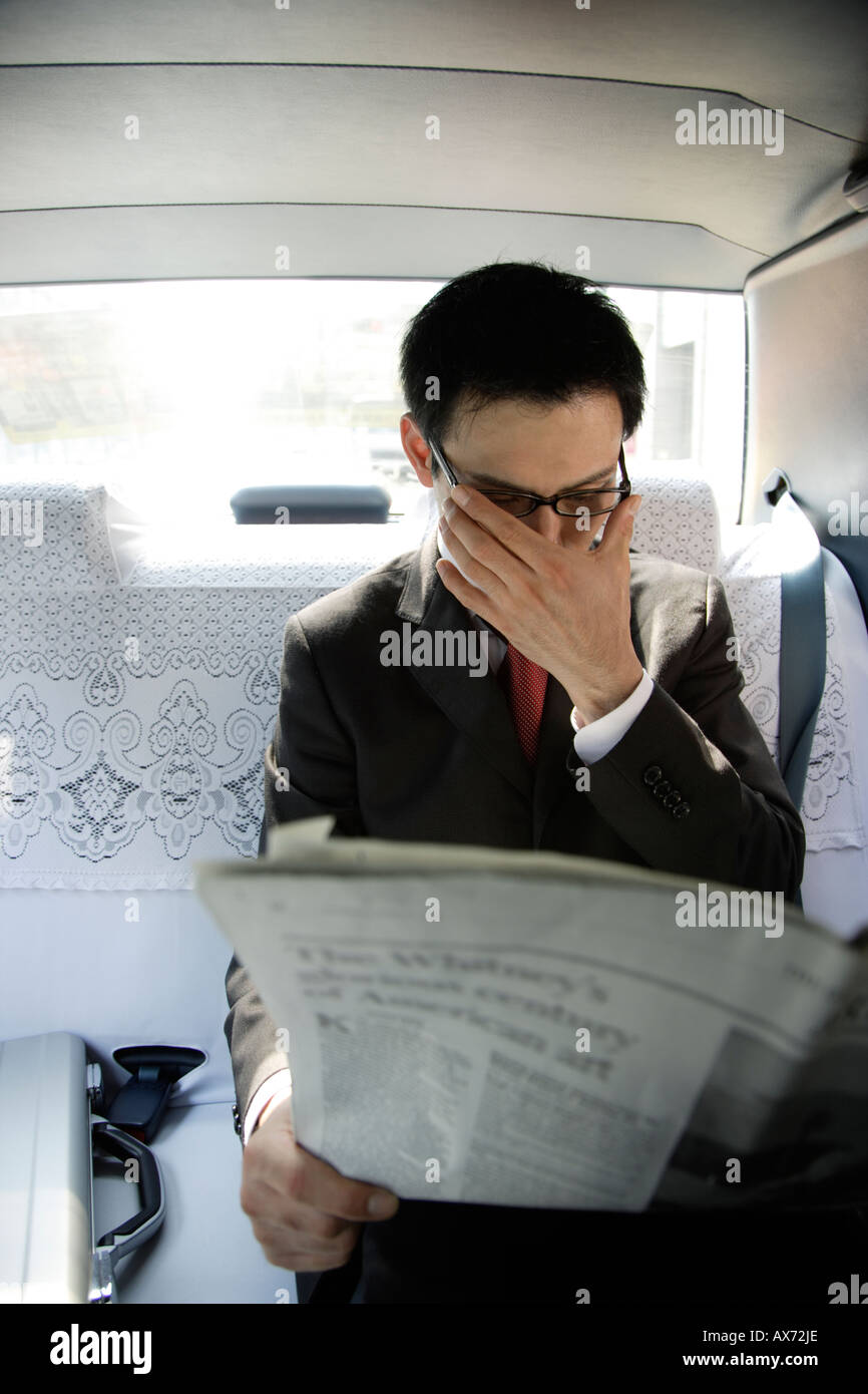 Businessman reading newspaper in car hi-res stock photography and ...