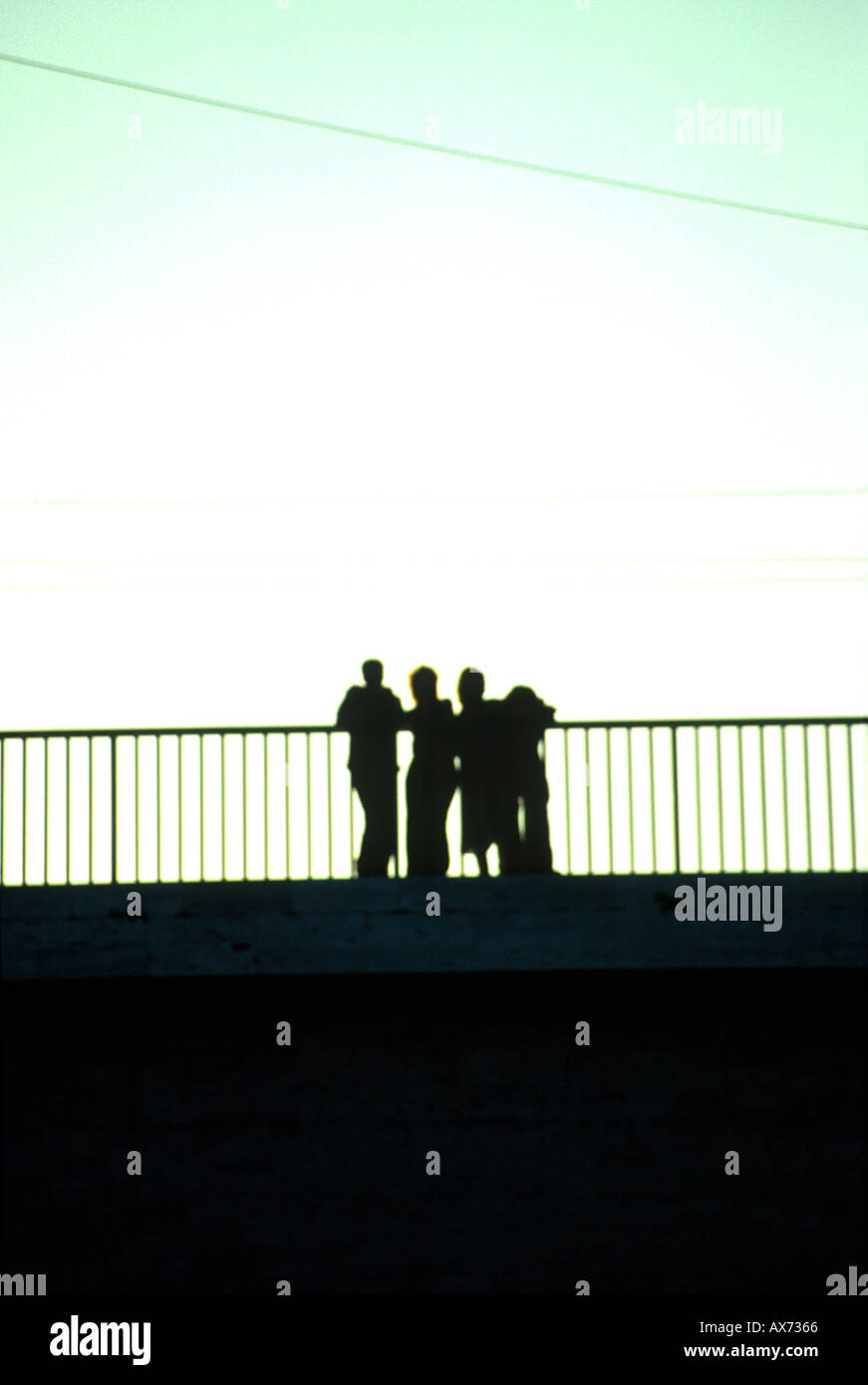 four people standing on bridge Stock Photo - Alamy